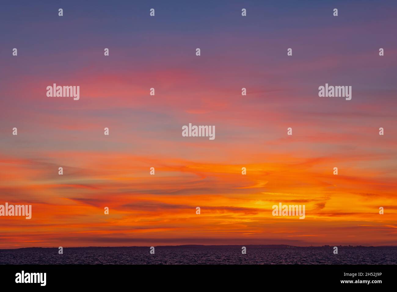 The setting sun lighting up the cloud cover Stock Photo - Alamy