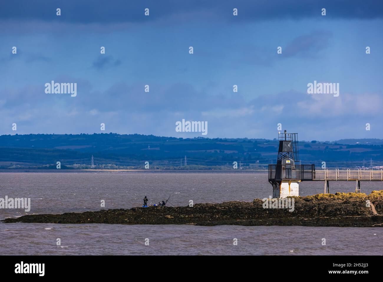 Fishermen on the rocks Portishead battery point Stock Photo - Alamy