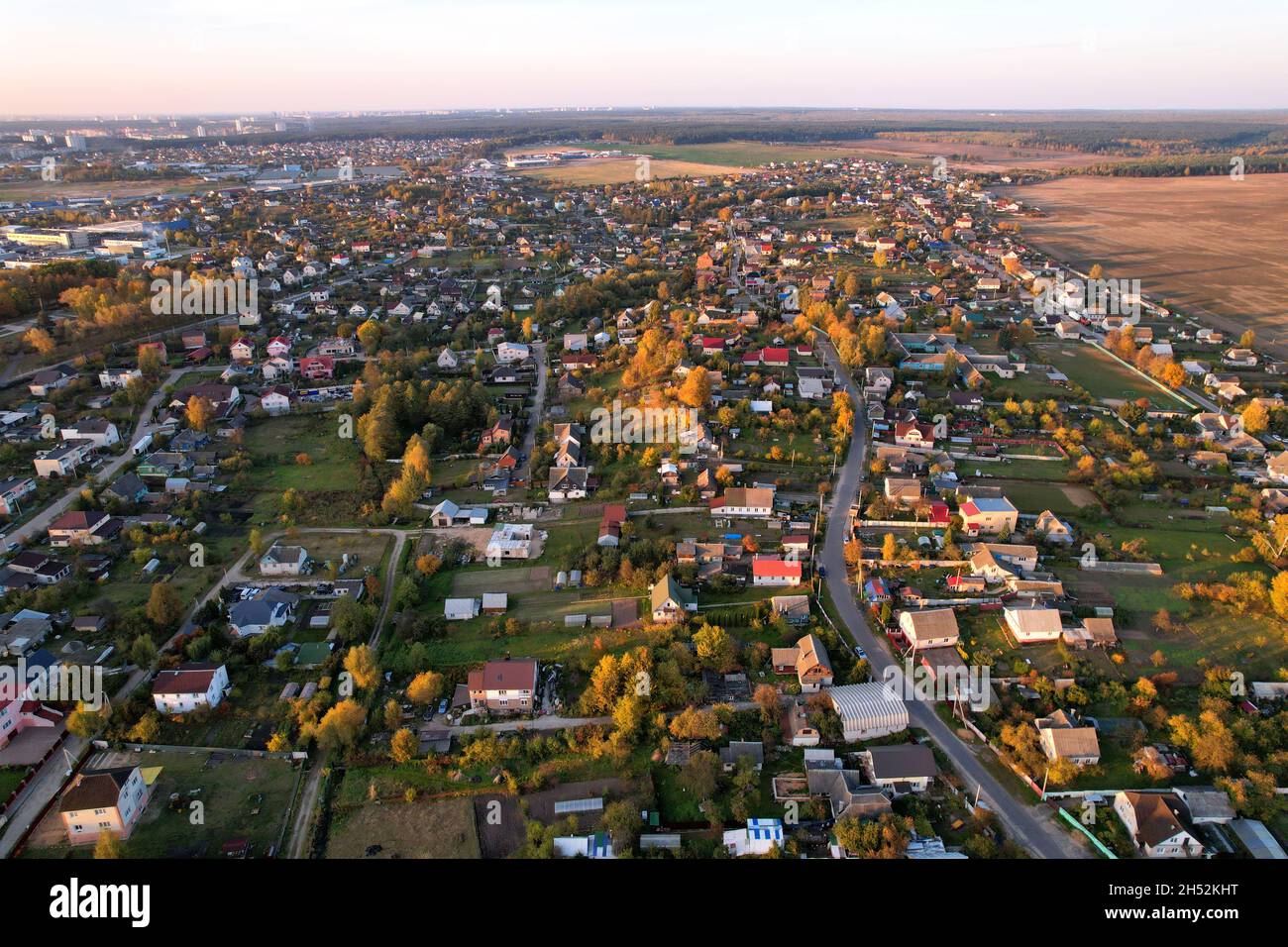 Country houses in the countryside. Aerial view of roofs of green field ...