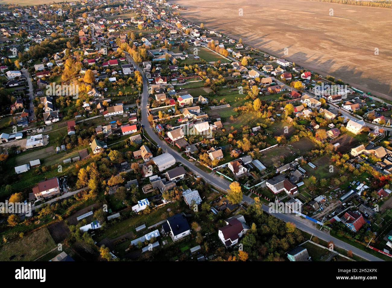 Country houses in the countryside. Aerial view of roofs of green field ...