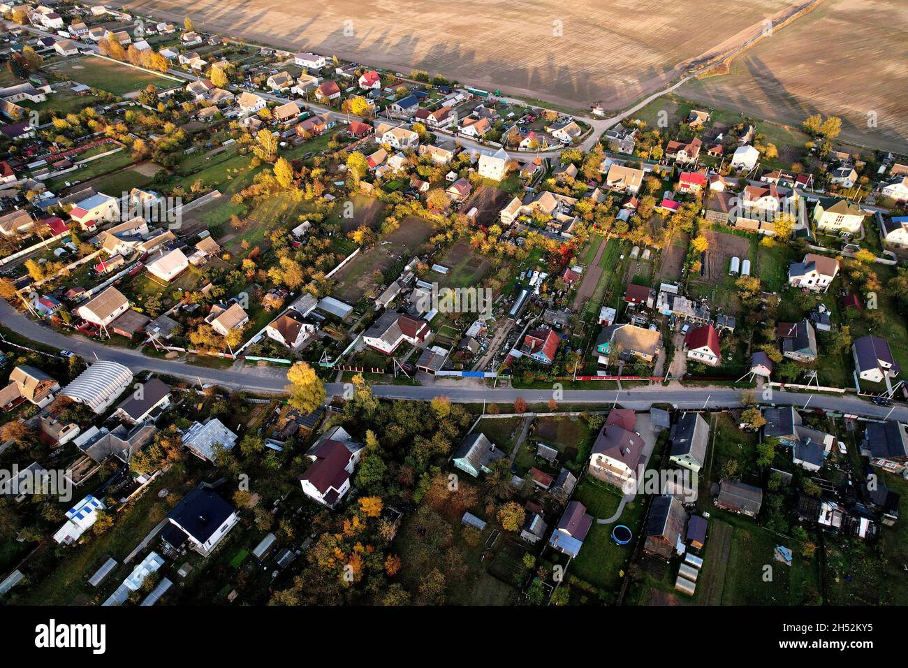 Country houses in the countryside. Aerial view of roofs of green field ...