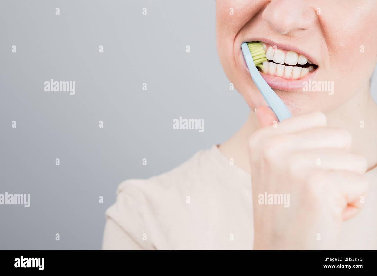 Close-up portrait of caucasian woman brushing her teeth. The girl ...