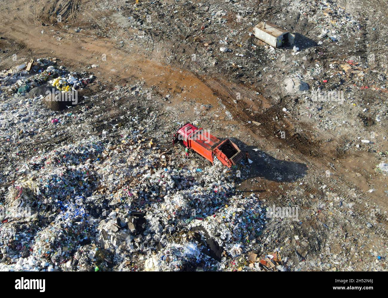 Arial view of garbage truck during unloading the rubbish and food waste ...