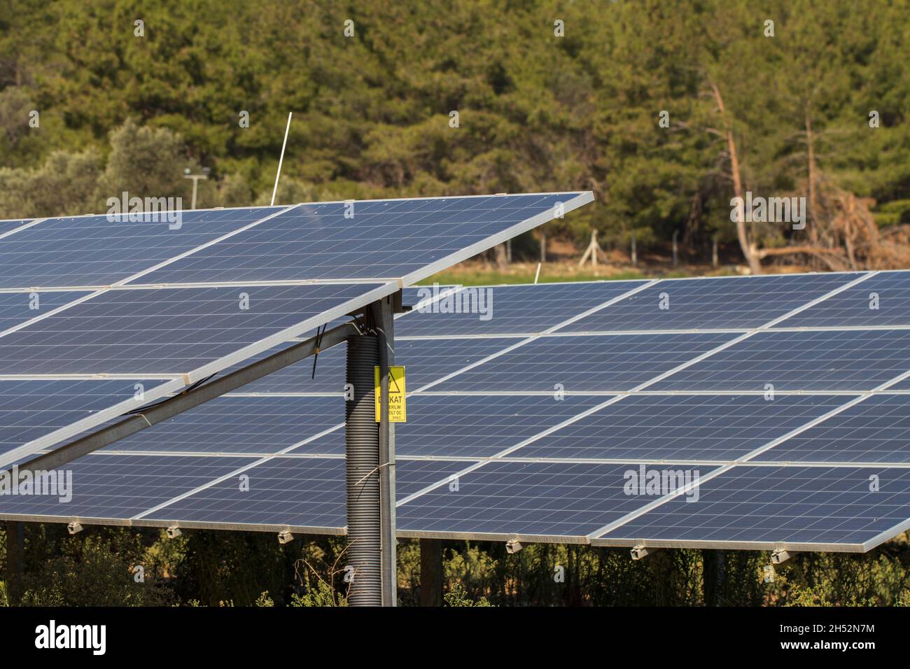 Closeup of electrical solar systems in a field collecting sun rays for ...