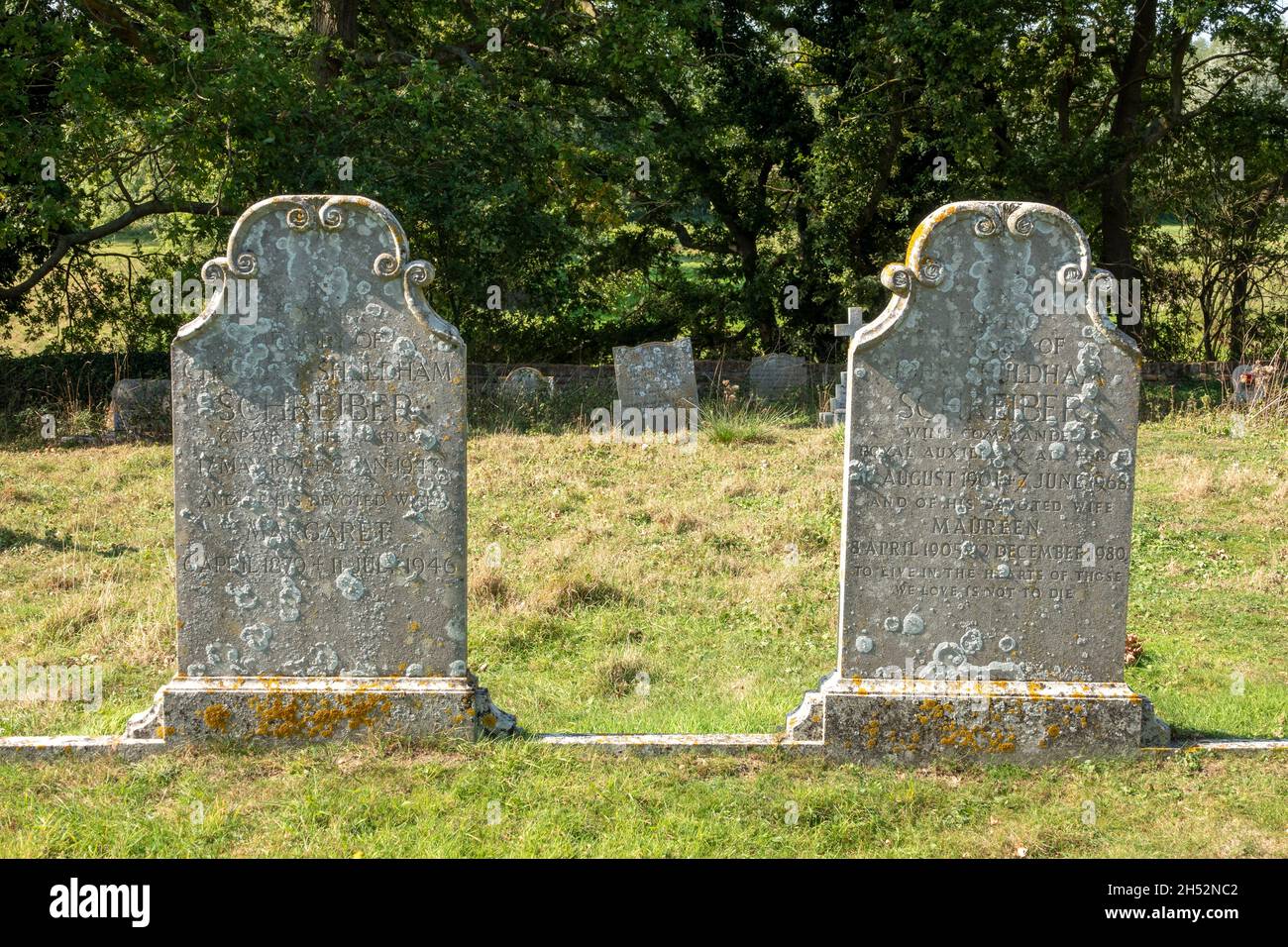 Two similar style ornate headstones with top scrolls for family of ...