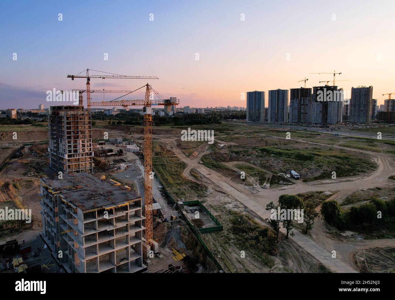 Tower crane on construction site on sunset background. Arial view of ...