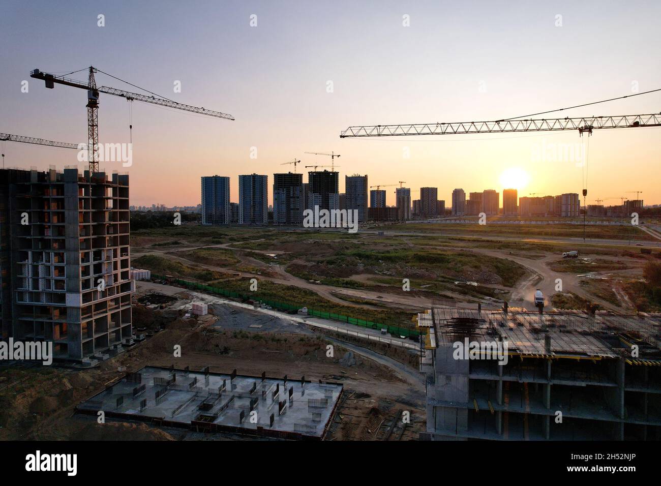 Tower crane on construction site on sunset background. Arial view of ...