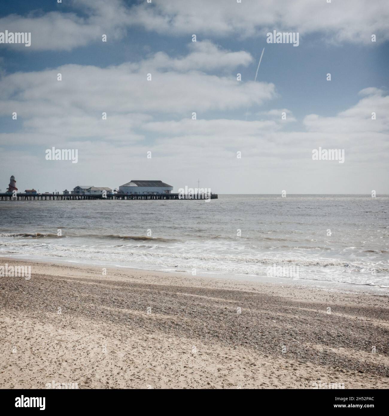 Clacton Pier (Clacton-on-sea, Essex, UK) on horizon; sea and beach in ...