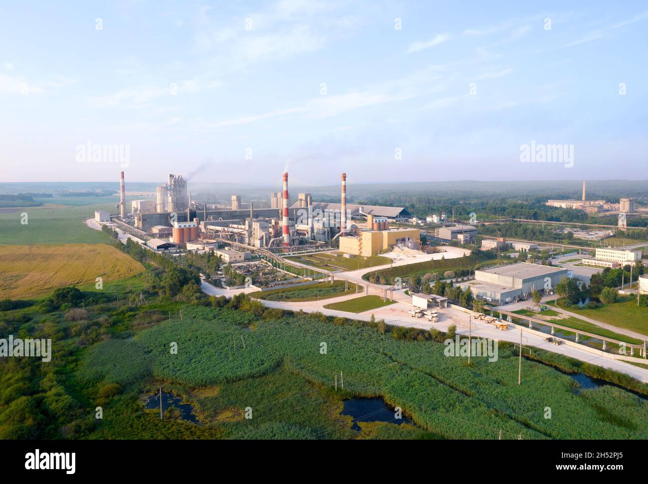 View of the cement plant with pipes. Industrial factory with smoke frow ...