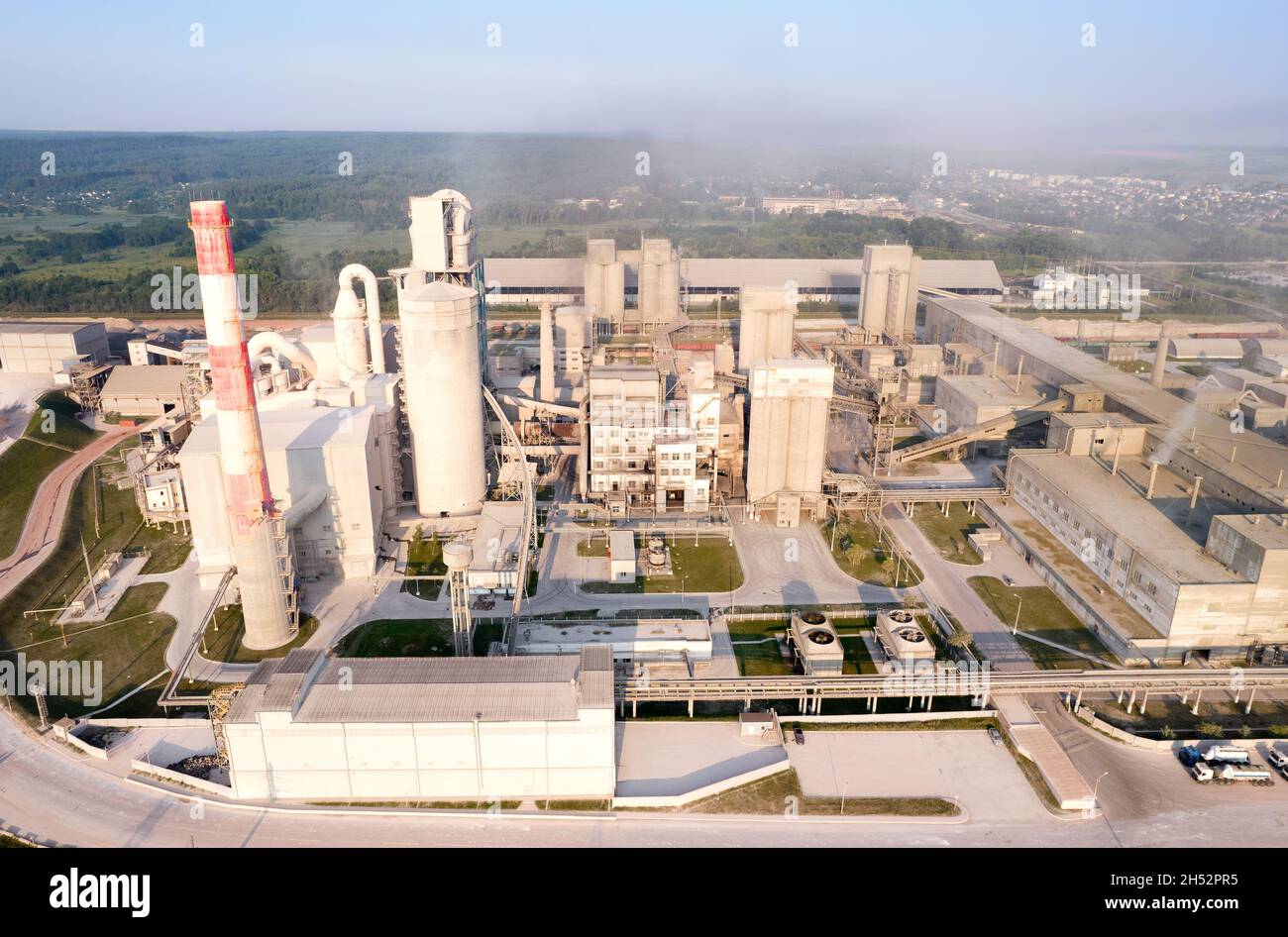 View of the cement plant with pipes. Industrial factory with smoke frow ...