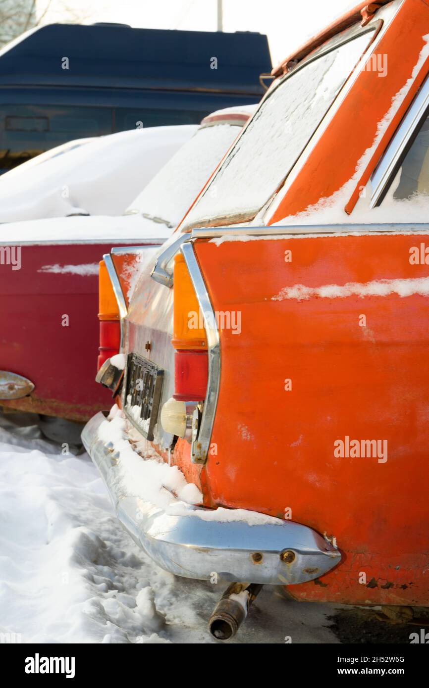 old broken vintage red rusty retro car parked in winter on snow ...