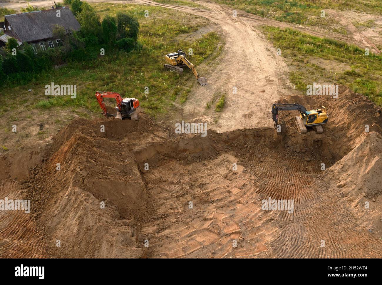 Excavator dig ground at a construction site. Trench for laying external ...
