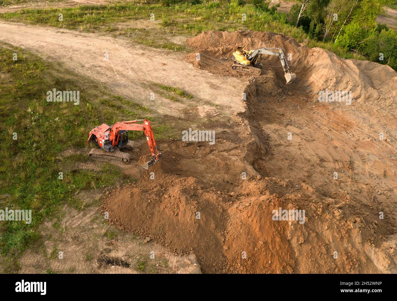 Excavator dig ground at a construction site. Trench for laying external ...