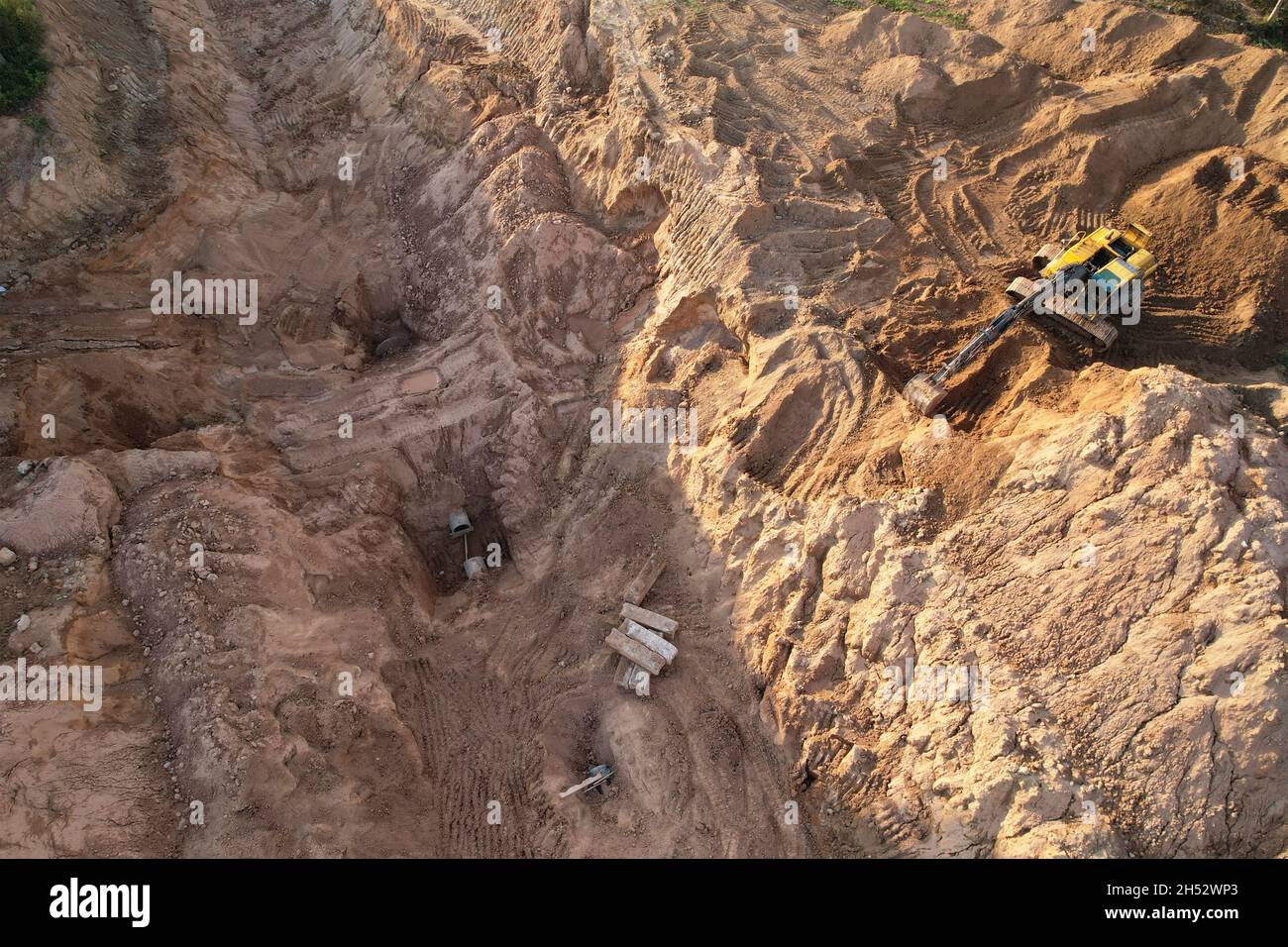 Excavator dig ground at construction site. Foundation pit for a multi ...