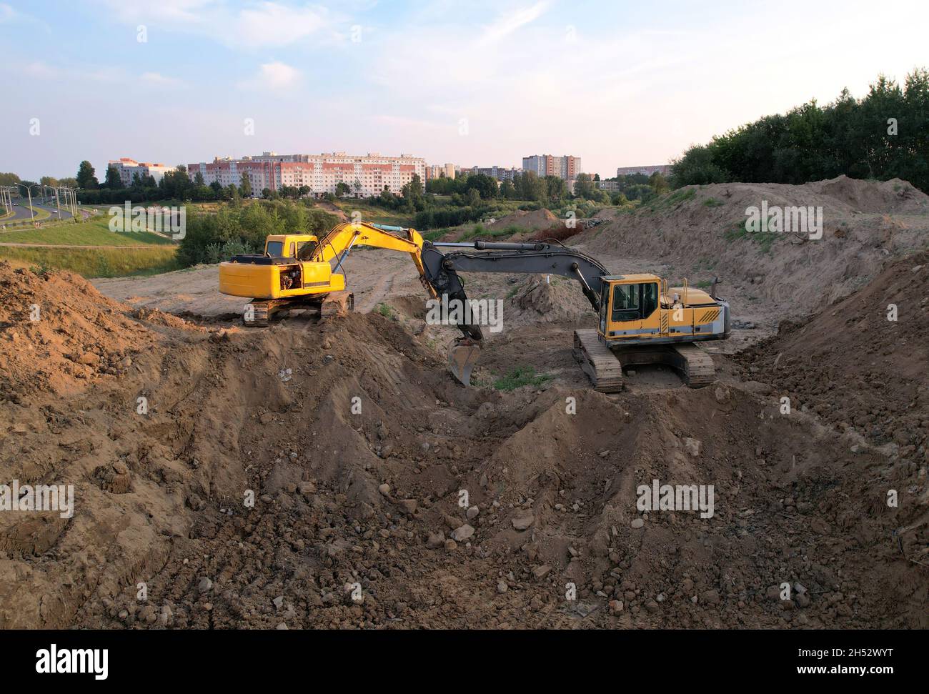 Excavator dig ground at construction site. Foundation pit for a multi ...