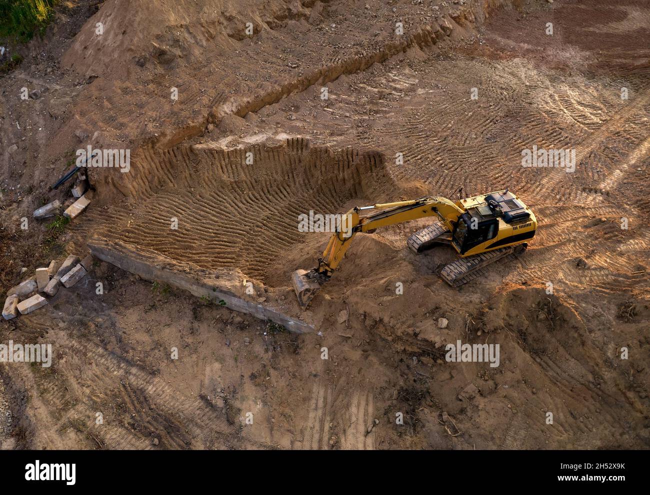 Excavator dig ground at construction site. Foundation pit for a multi ...