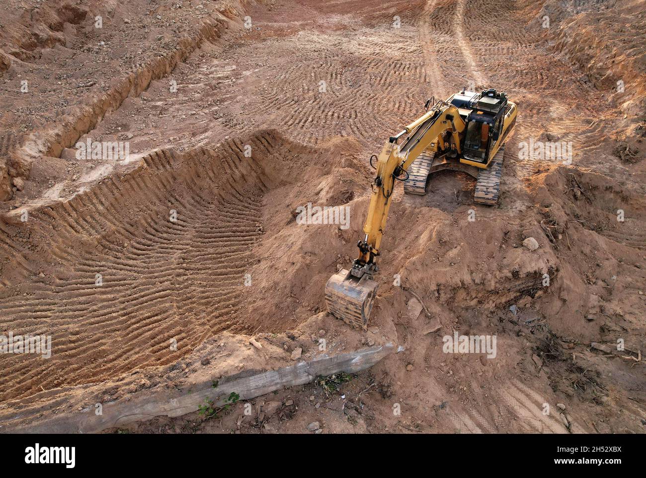 Excavator dig ground at construction site. Foundation pit for a multi ...