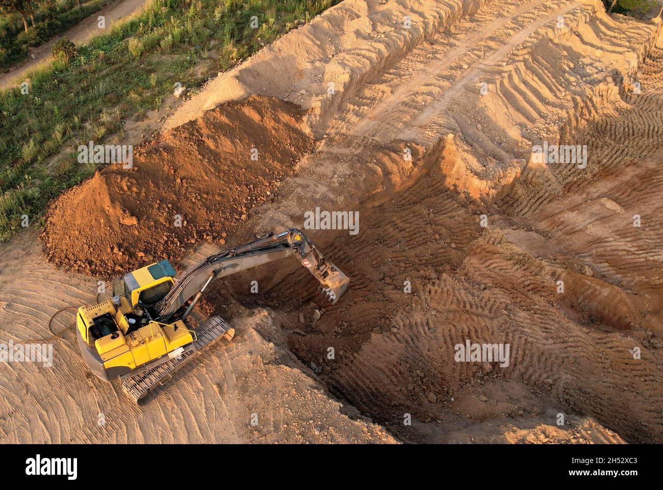 Excavator dig ground at construction site. Foundation pit for a multi ...