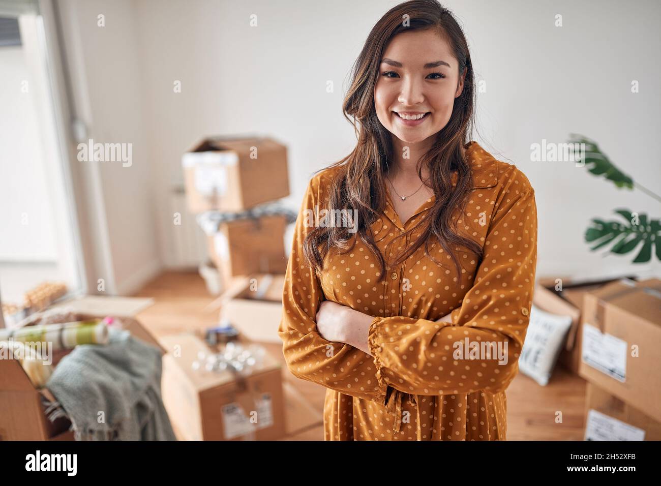 Asian woman moving into a new living place Stock Photo - Alamy