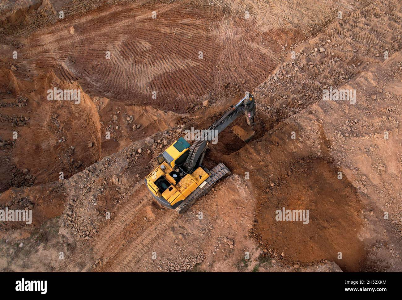 Excavator dig ground at construction site. Foundation pit for a multi ...