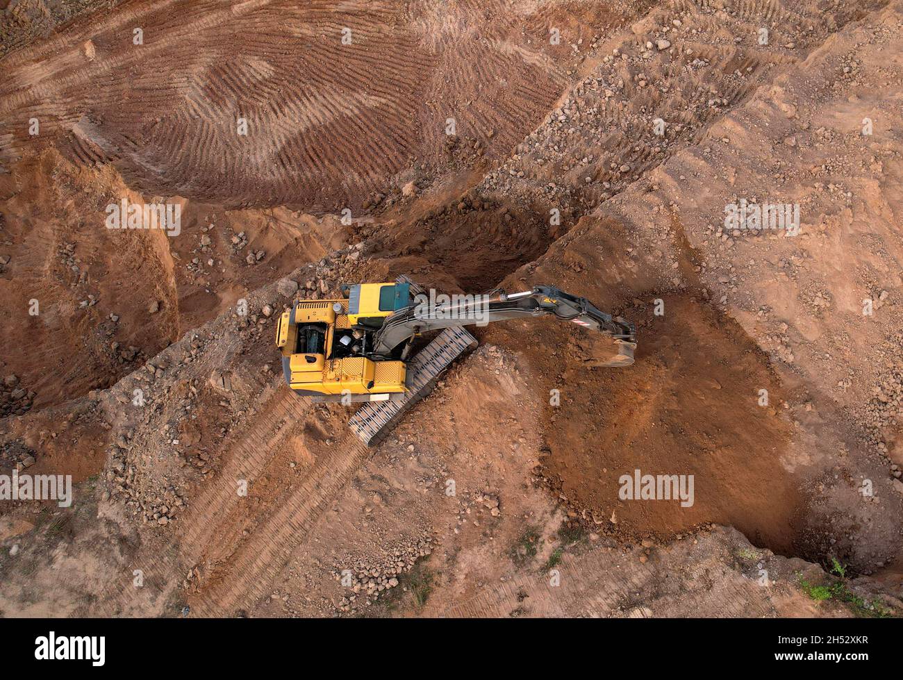 Excavator dig ground at construction site. Foundation pit for a multi ...