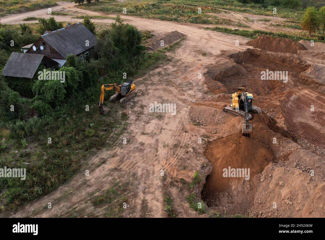 Excavator dig ground at construction site. Foundation pit for a multi ...