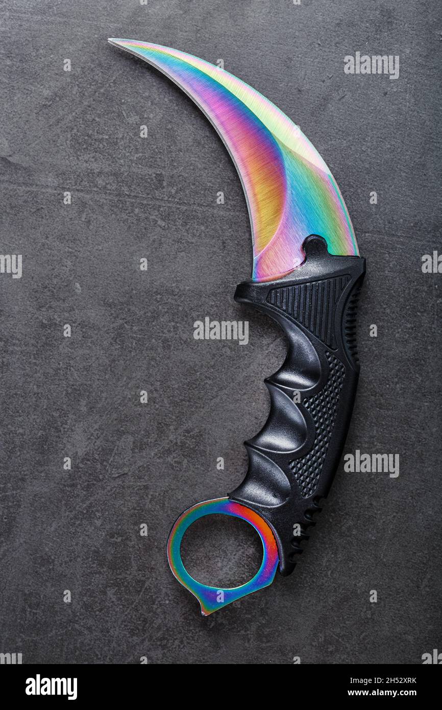 A dagger with a steel blade with a gradient color on a black background ...