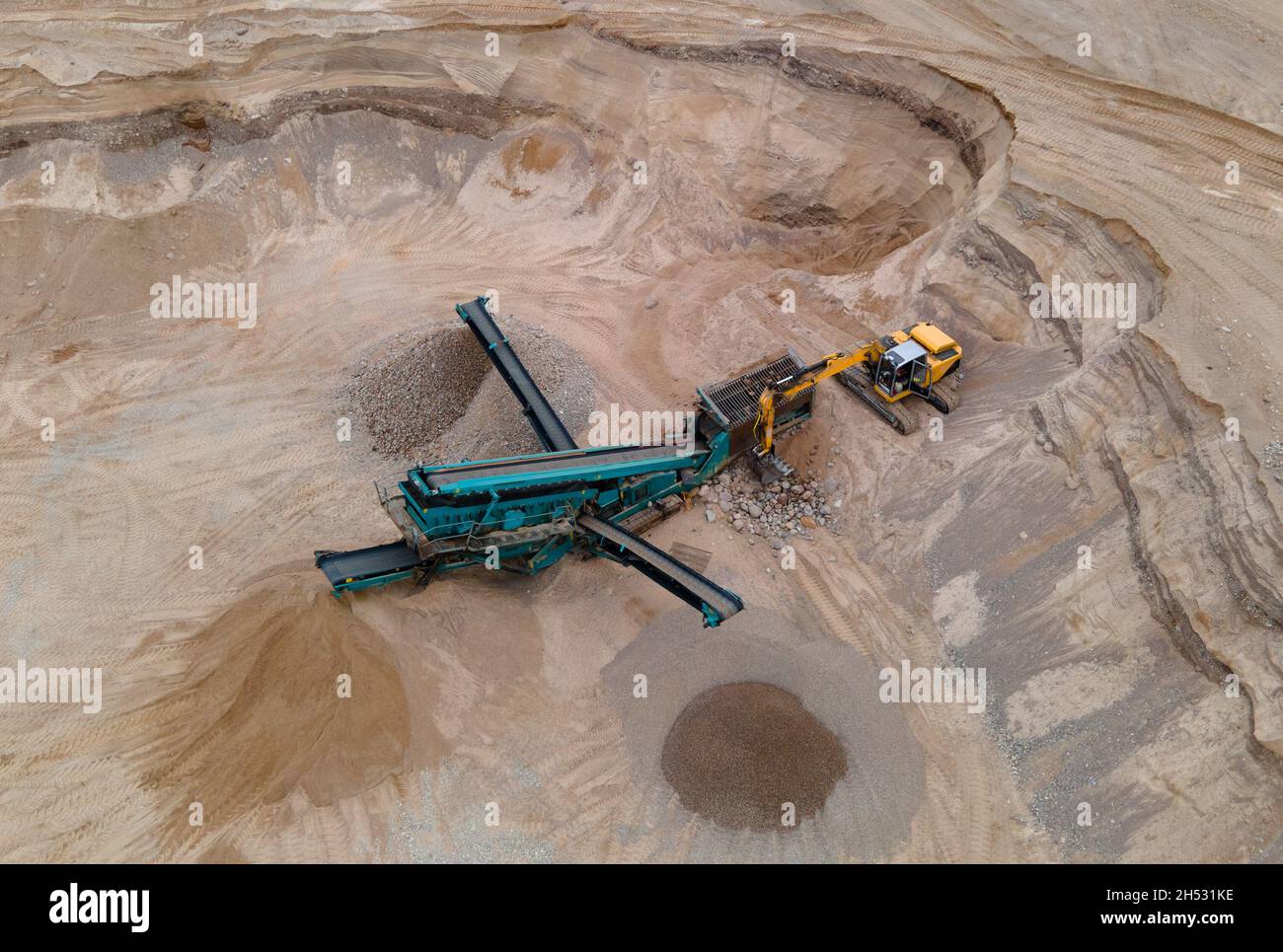 Arial view of the open pit mine. Front end loader loading gravel into ...