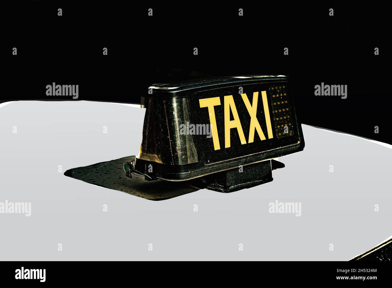 White Taxi top sign with yellow lettering and black background Stock ...