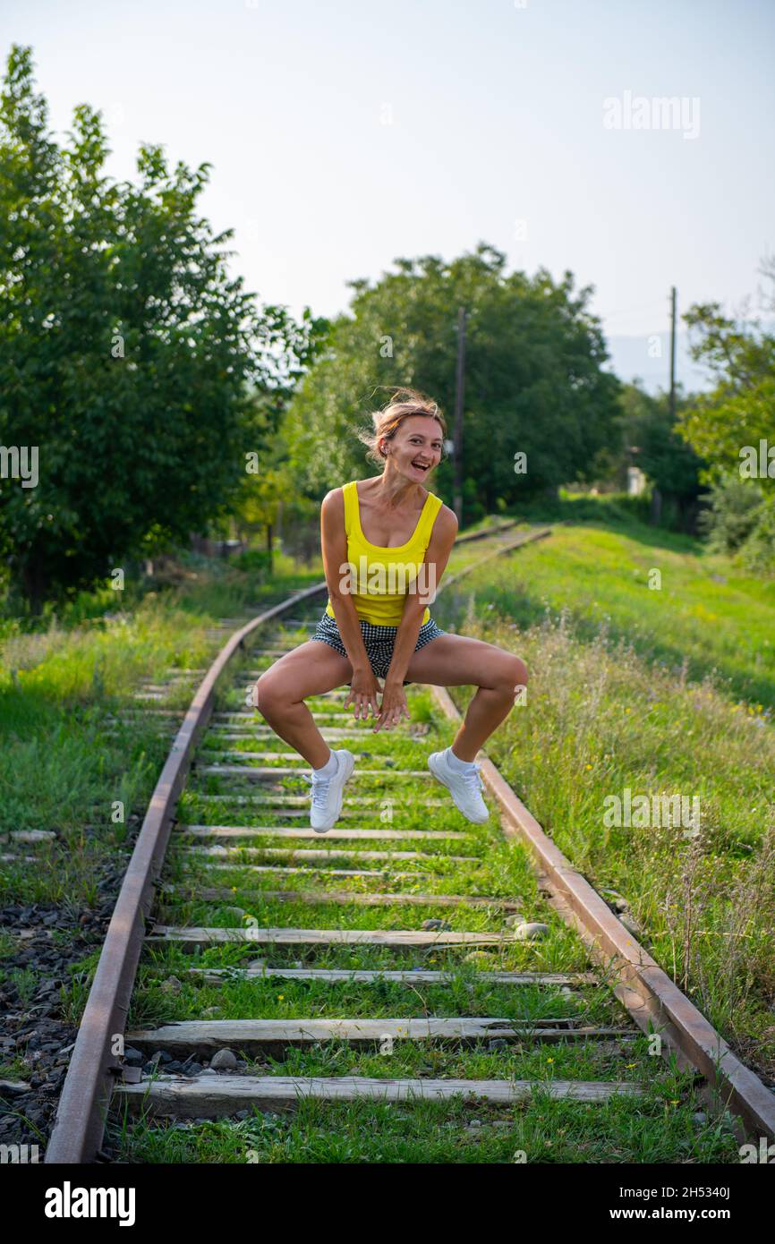 nimble girl jumping on the railroad tracks Stock Photo - Alamy