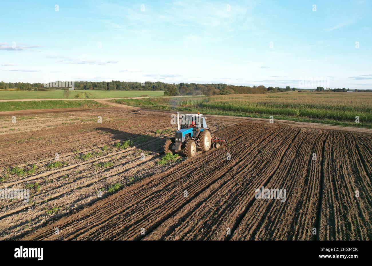 Tractor with Plough on Plowed. Ploughing and Soil Tillage. Agricultural ...