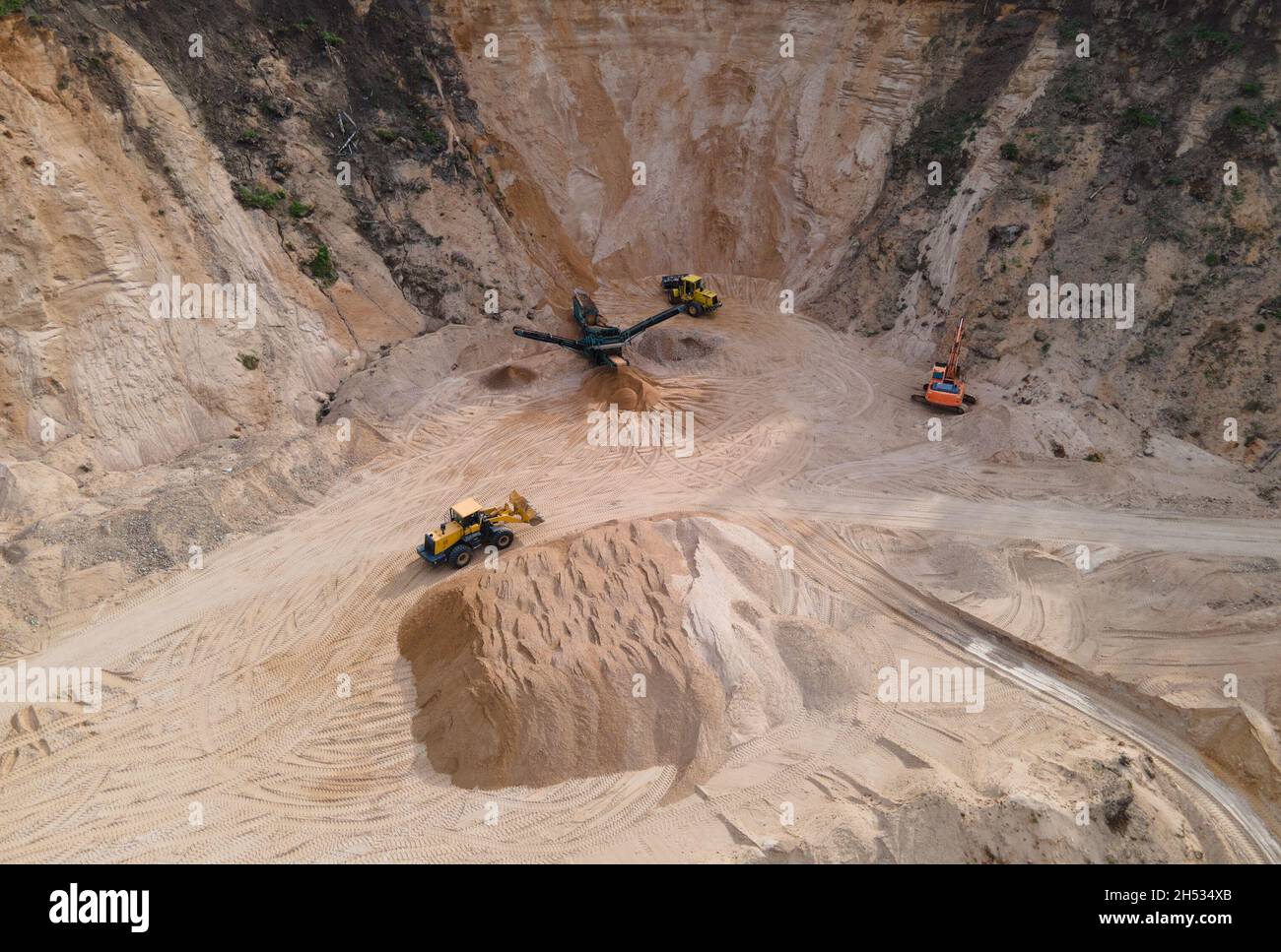 Arial view of the open pit mine. Front end loader loading gravel into ...