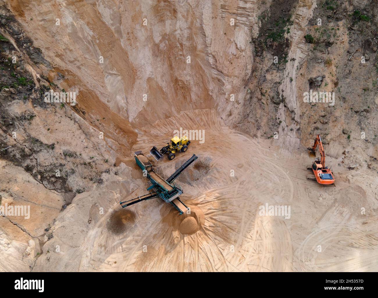 Arial view of the open pit mine. Front end loader loading gravel into ...