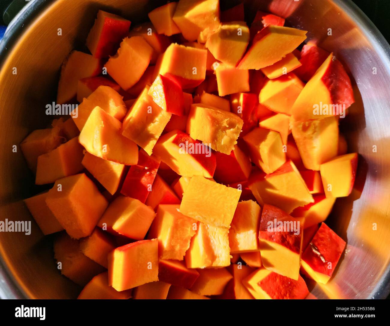 Chopped pimpkin pieces in a bowl - top view Stock Photo - Alamy