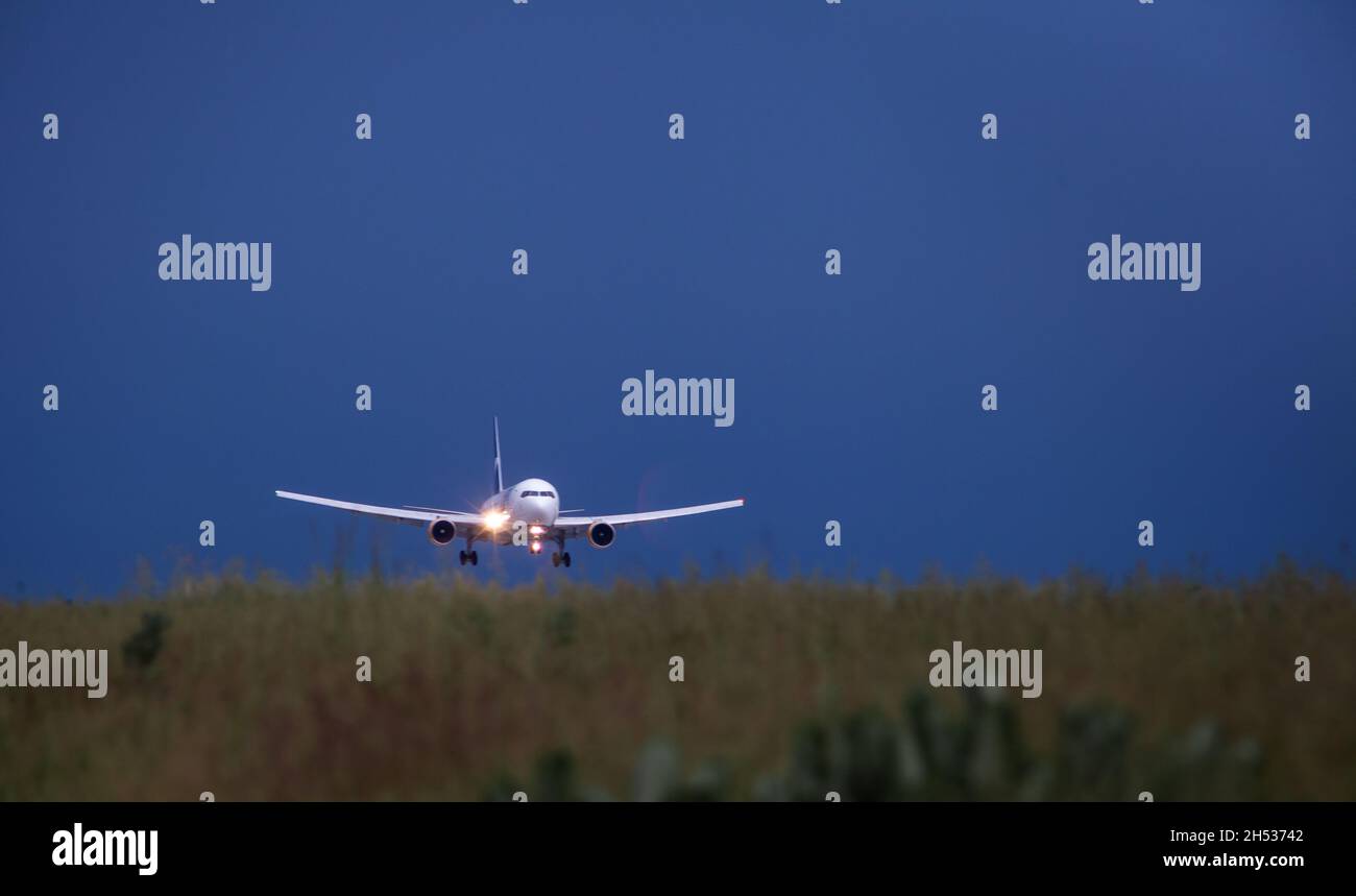 Night flight. The plane lands on the runway. Dust. Dark sky. Copy space ...