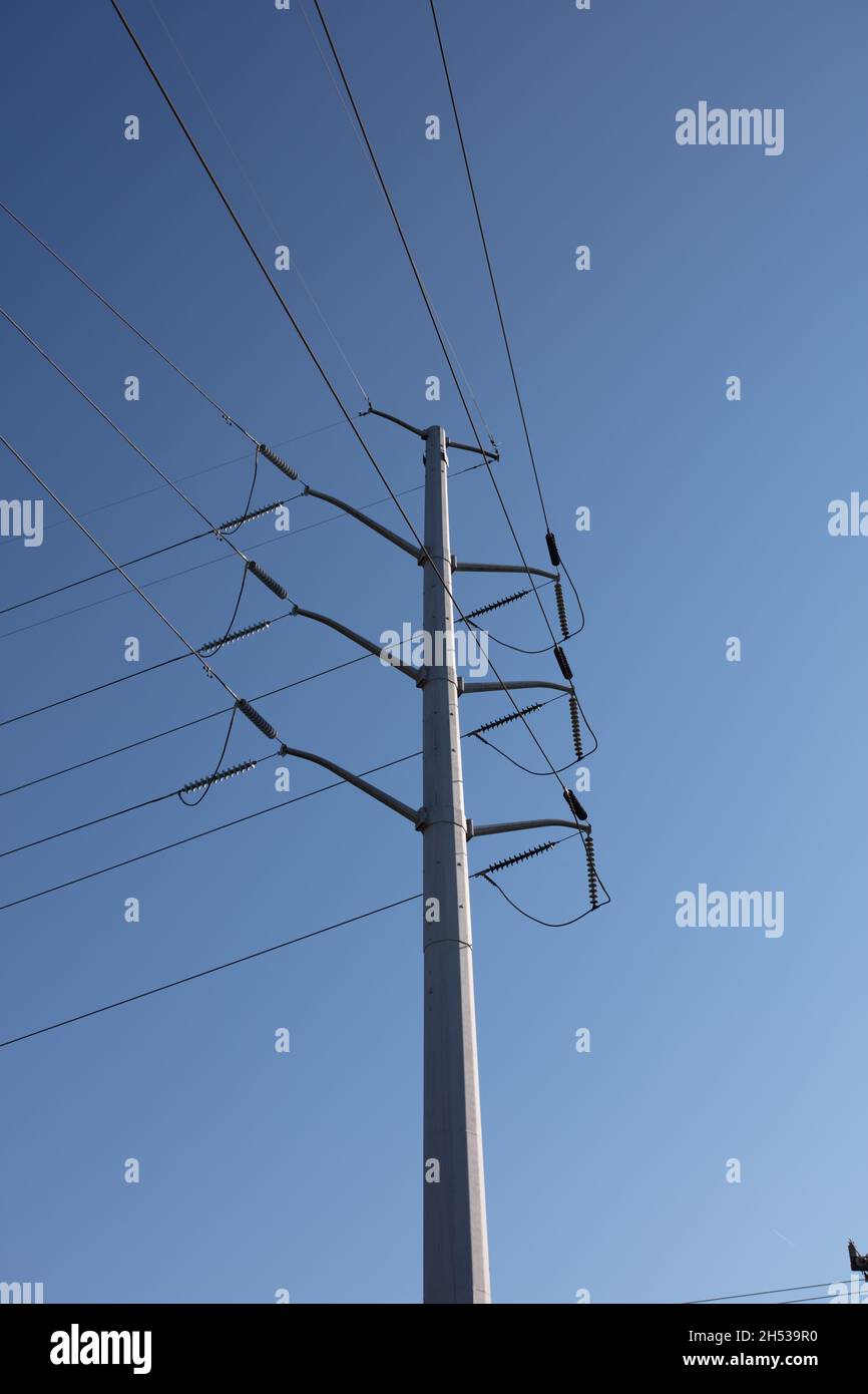 Vertical low angle shot of transmission towers under the daylight sky ...