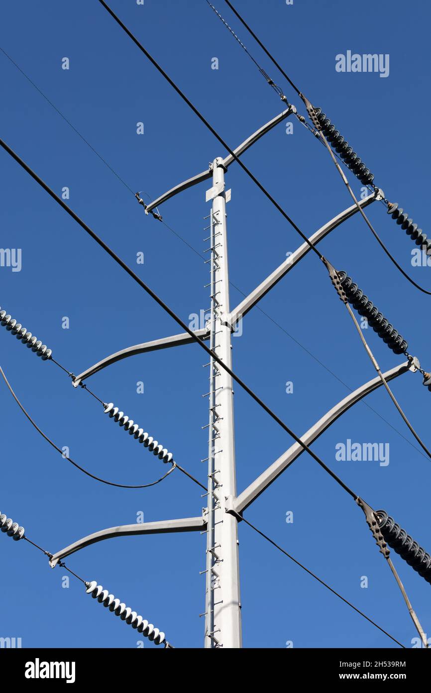 Vertical low angle shot of transmission towers under the daylight sky ...