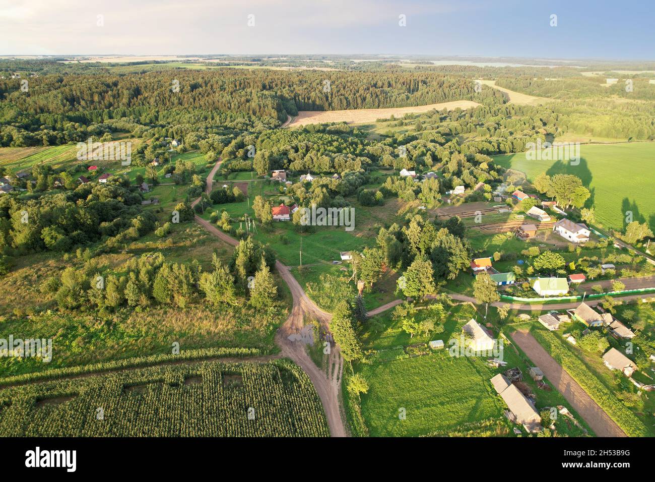 Country houses in the countryside. Aerial view of roofs of green field ...