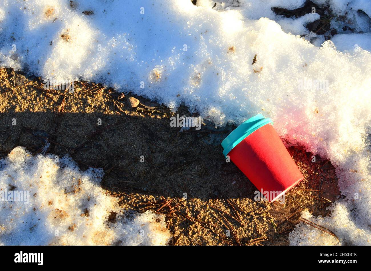 People throw coffee cup on snow. The problem of environmental pollution ...