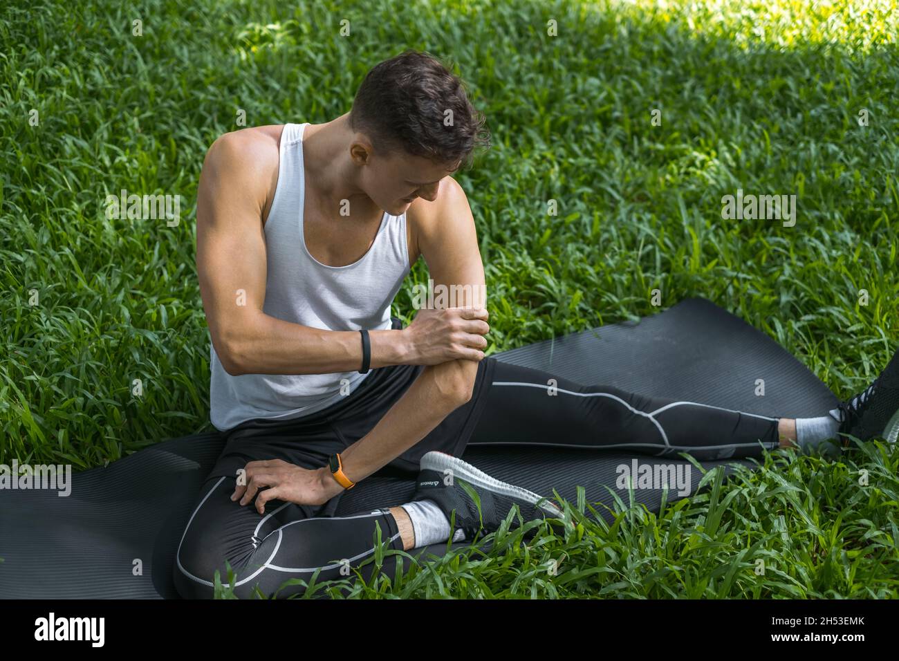 Close up portrait of man touching his arm with his hand. Man injured ...