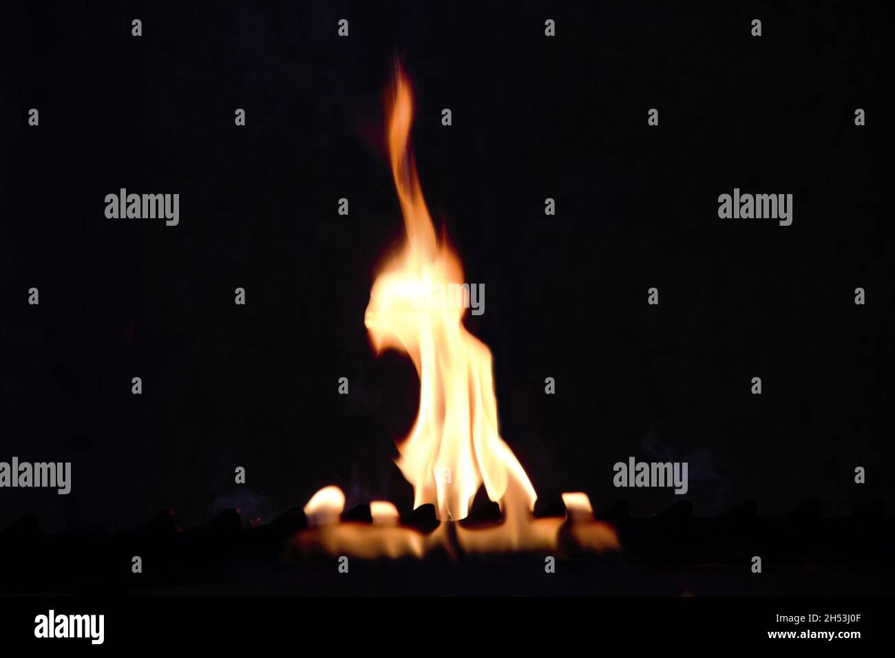 Flame of some candles, blurred on black background. Full screen Stock ...