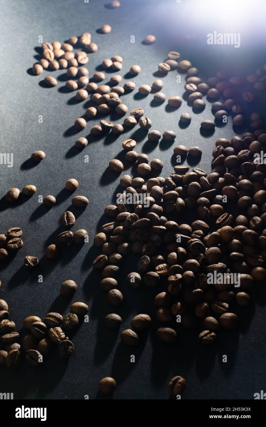 Several coffee beans isolated on black background with reflection ...