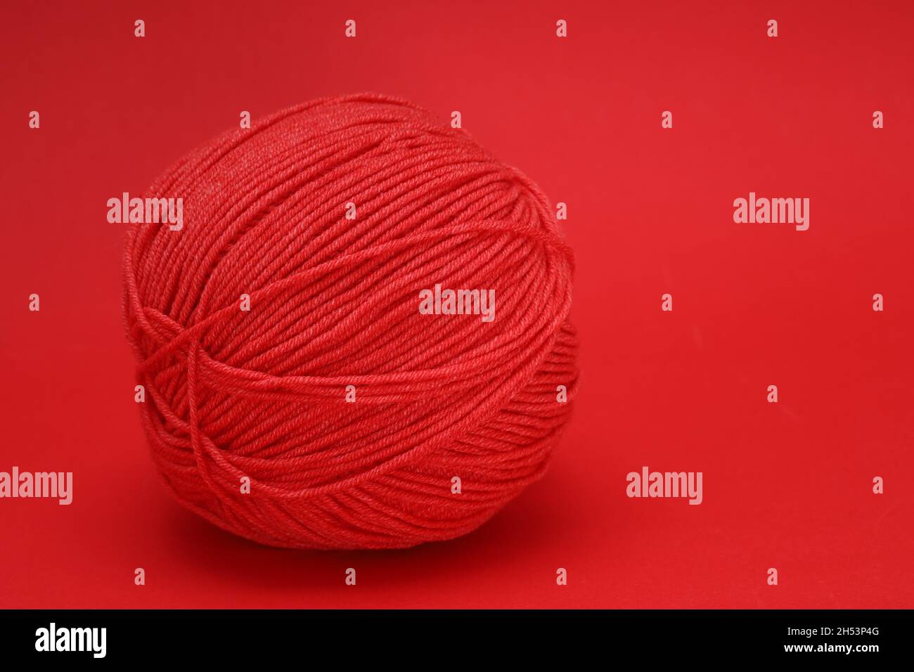 red wool ball on red background. High quality photo Stock Photo - Alamy