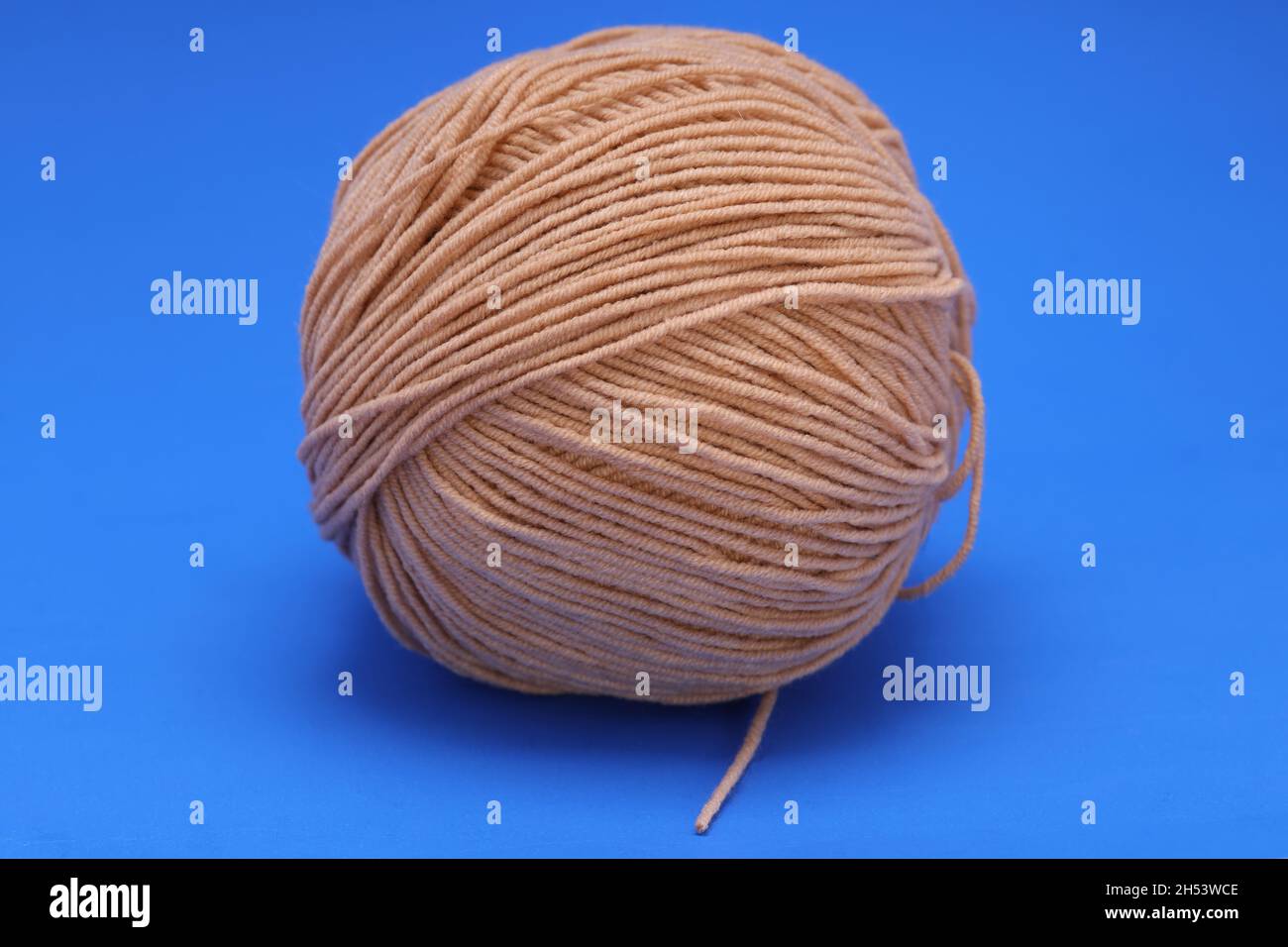 brown woolen ball on blue background. High quality photo Stock Photo ...
