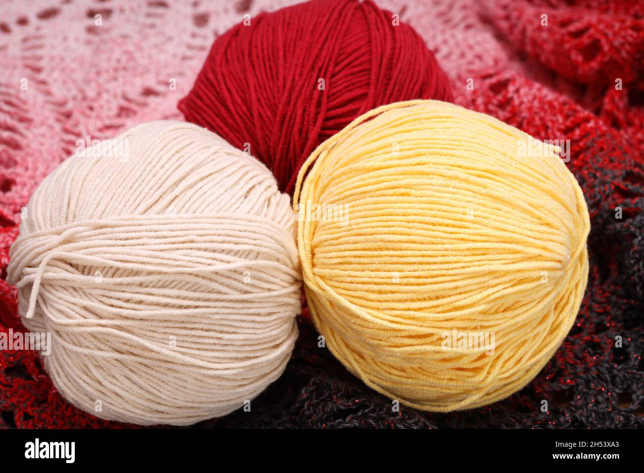 balls of wool lie on a knitted tablecloth. High quality photo Stock ...