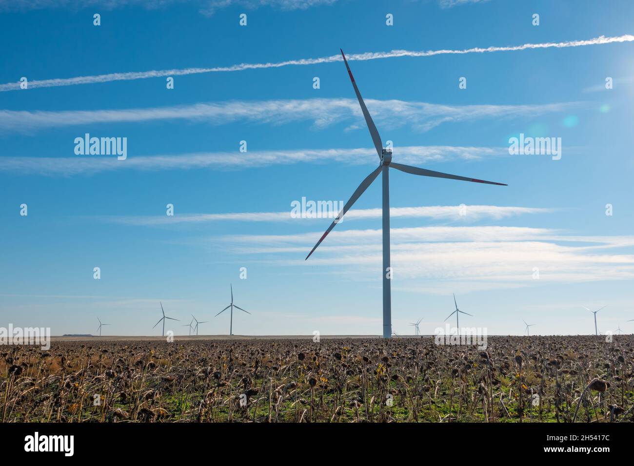 Wind turbines in open terrain on windy days with dark clouds in the sky ...
