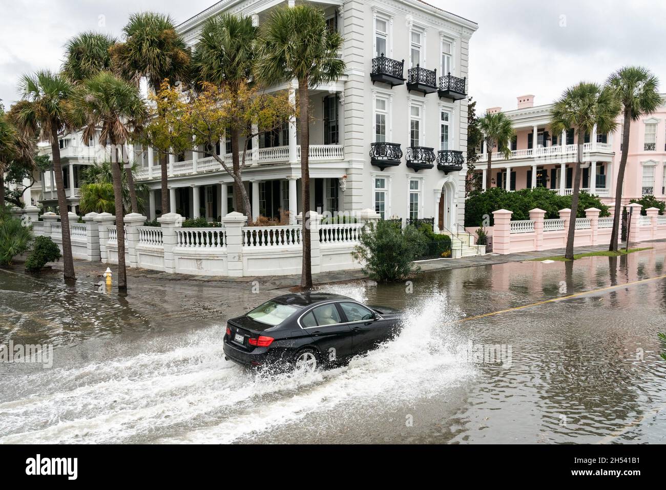 Charleston, United States. 06th Nov, 2021. A car drives through flood ...