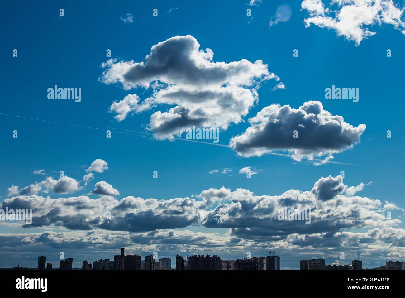 Cumulonimbus clouds over silhouettes of multi-storey buildings Stock ...