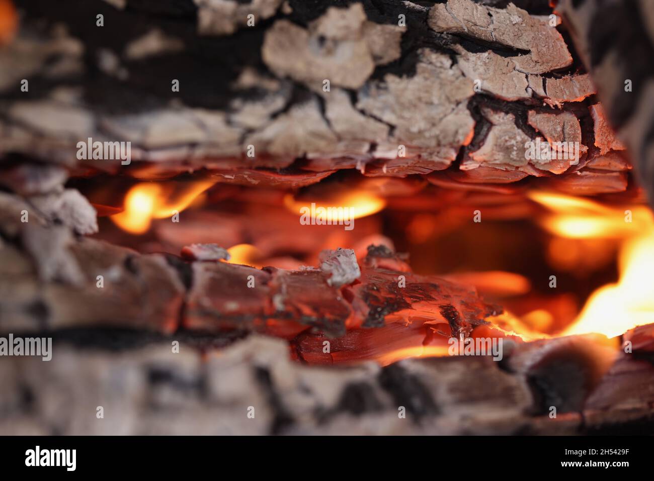 Fire is burning among wood closeup background Stock Photo - Alamy
