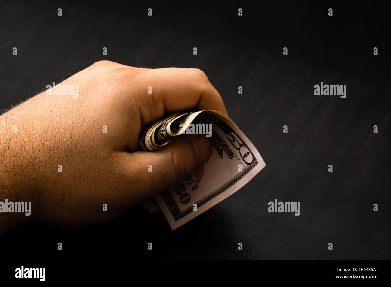 Hand holding bundles money hi-res stock photography and images - Alamy